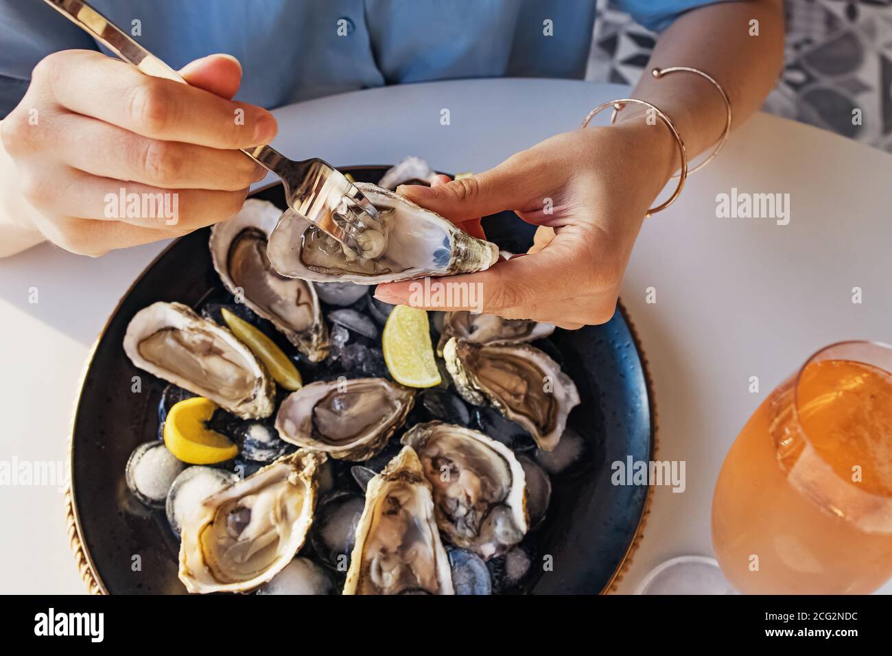 Person eating oysters restaurant hi-res stock photography and images ...