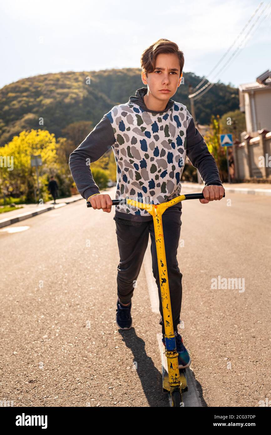 Teen boy in a a scooter hi-res stock photography and images - Alamy