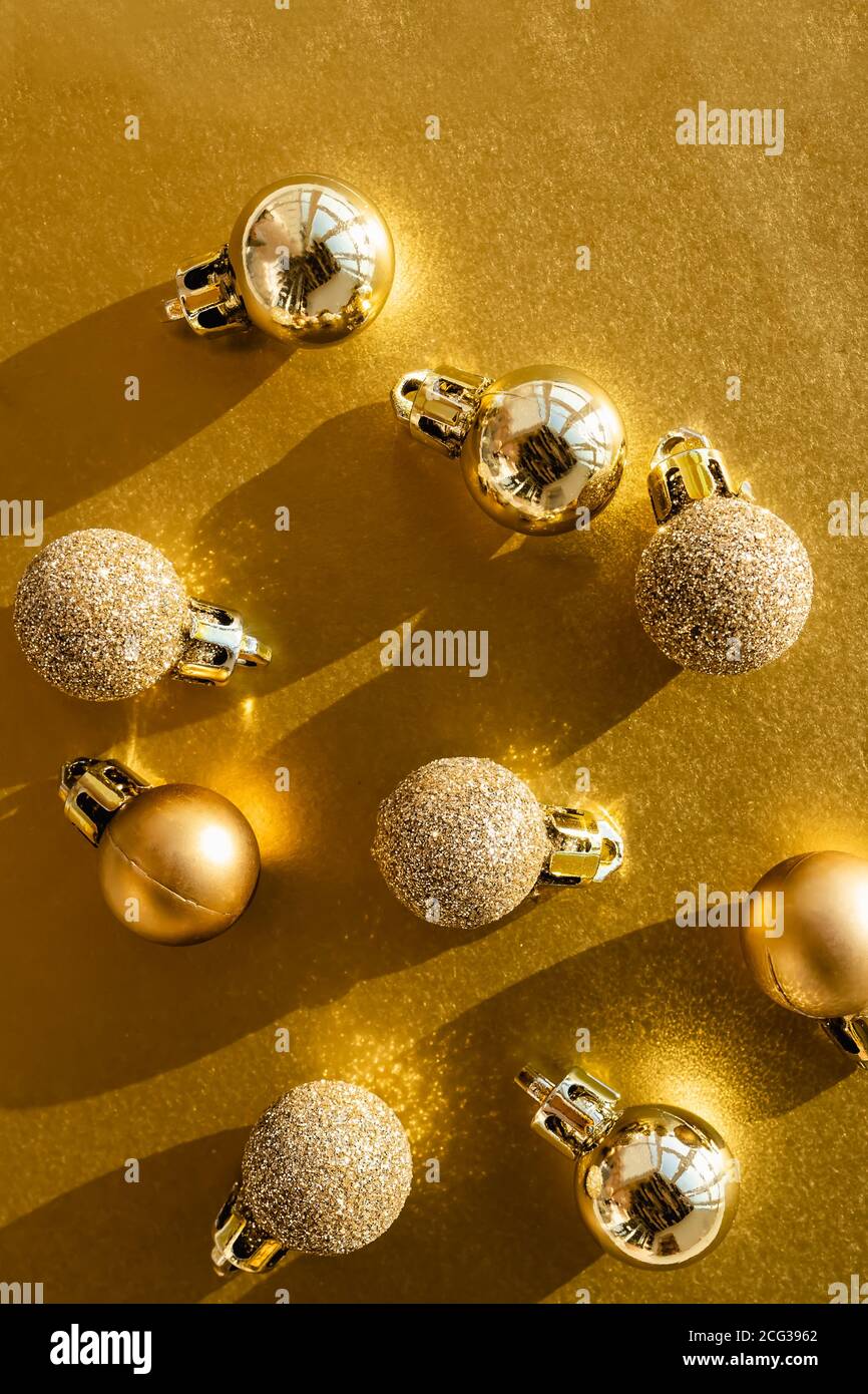 Christmas decor. Golden color baubles on gold background with hard ...