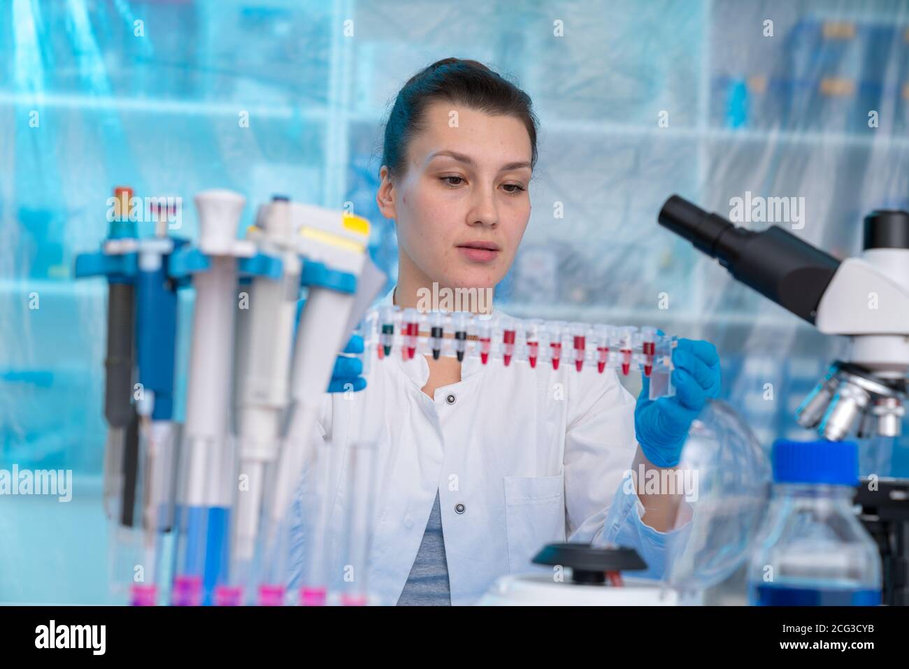 Young woman in clinical lab does PCR test on viral disease Stock Photo ...