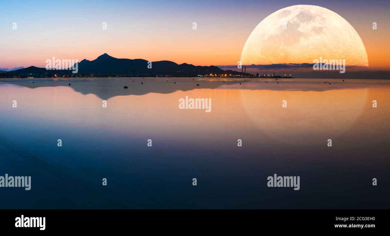 Fantastic landscape with a giant moon against the backdrop of a ...