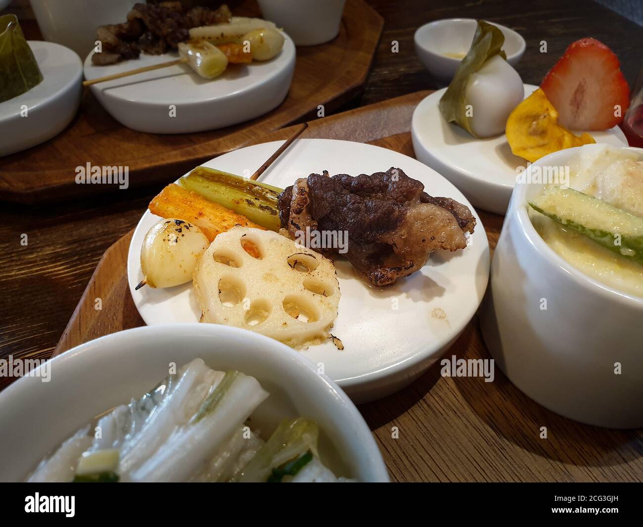 Fried lotus root and grilled brisket. Skewer with grilled garlic, root ...