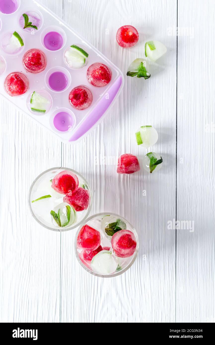 Raspberry and lime in ice cubes top view flat lay Stock Photo - Alamy