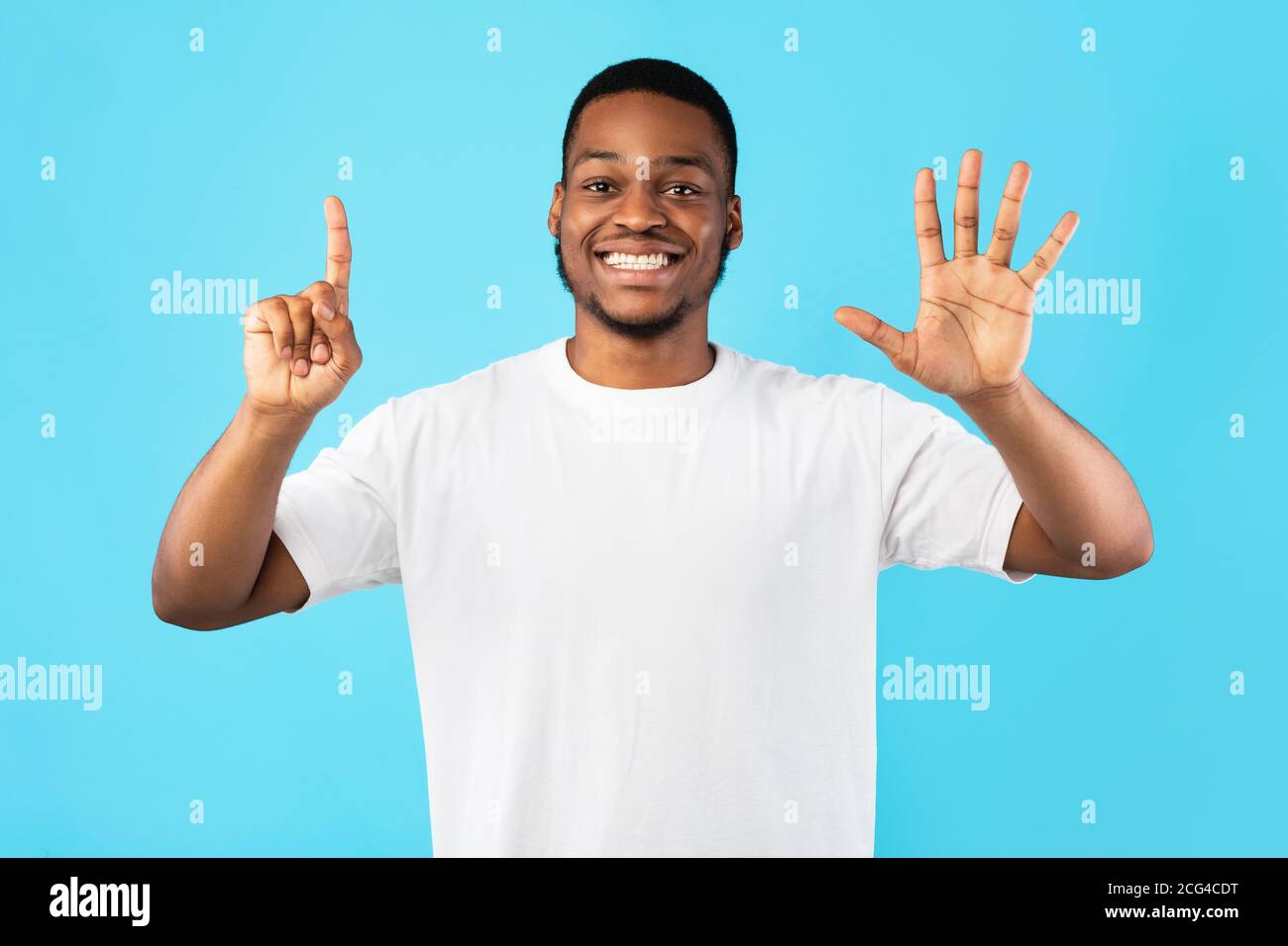 African Guy Counting Showing Number Six Standing Over Blue Background ...