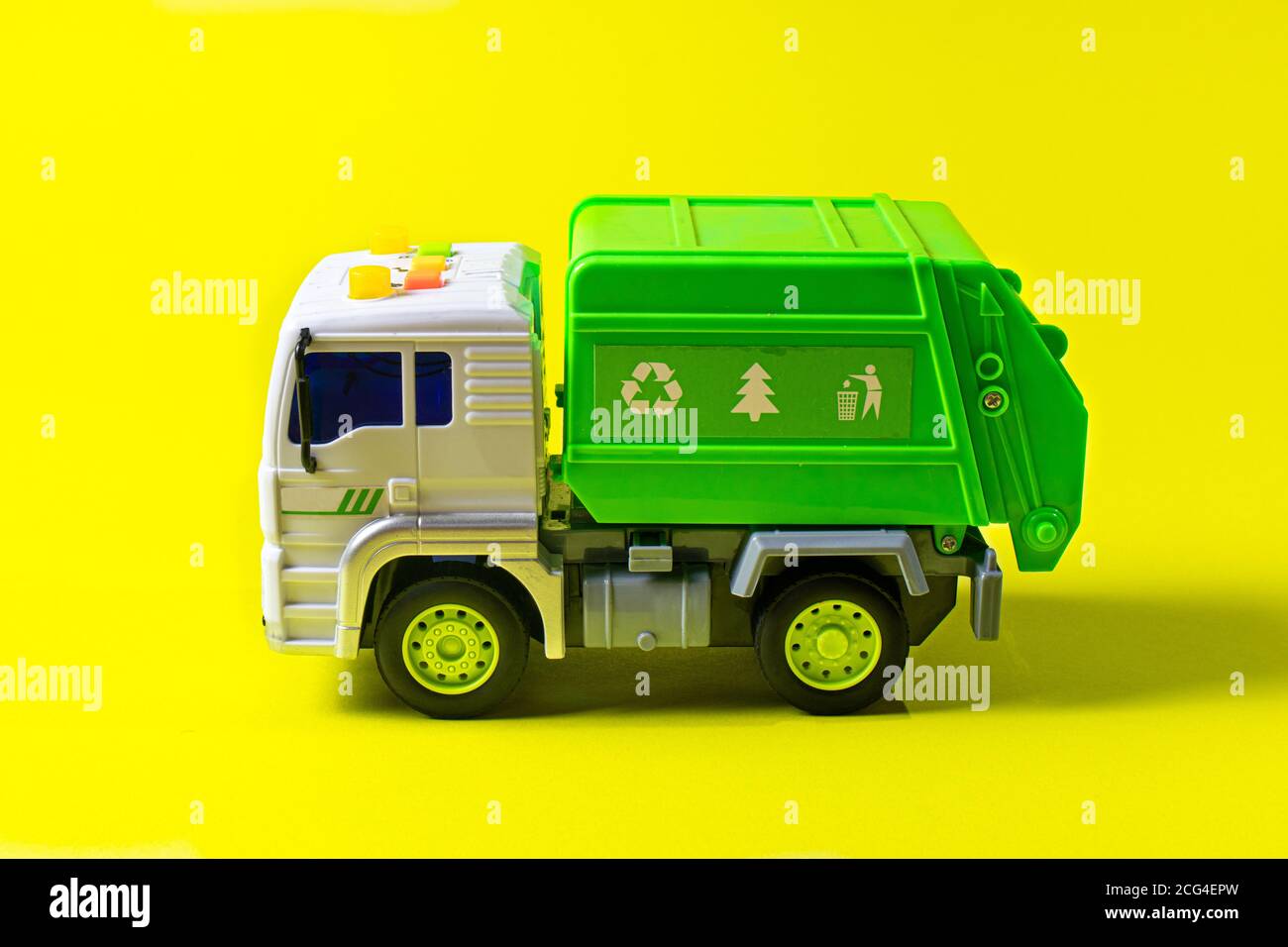 The toy garbage truck white-green with a yellow background. Children's ...