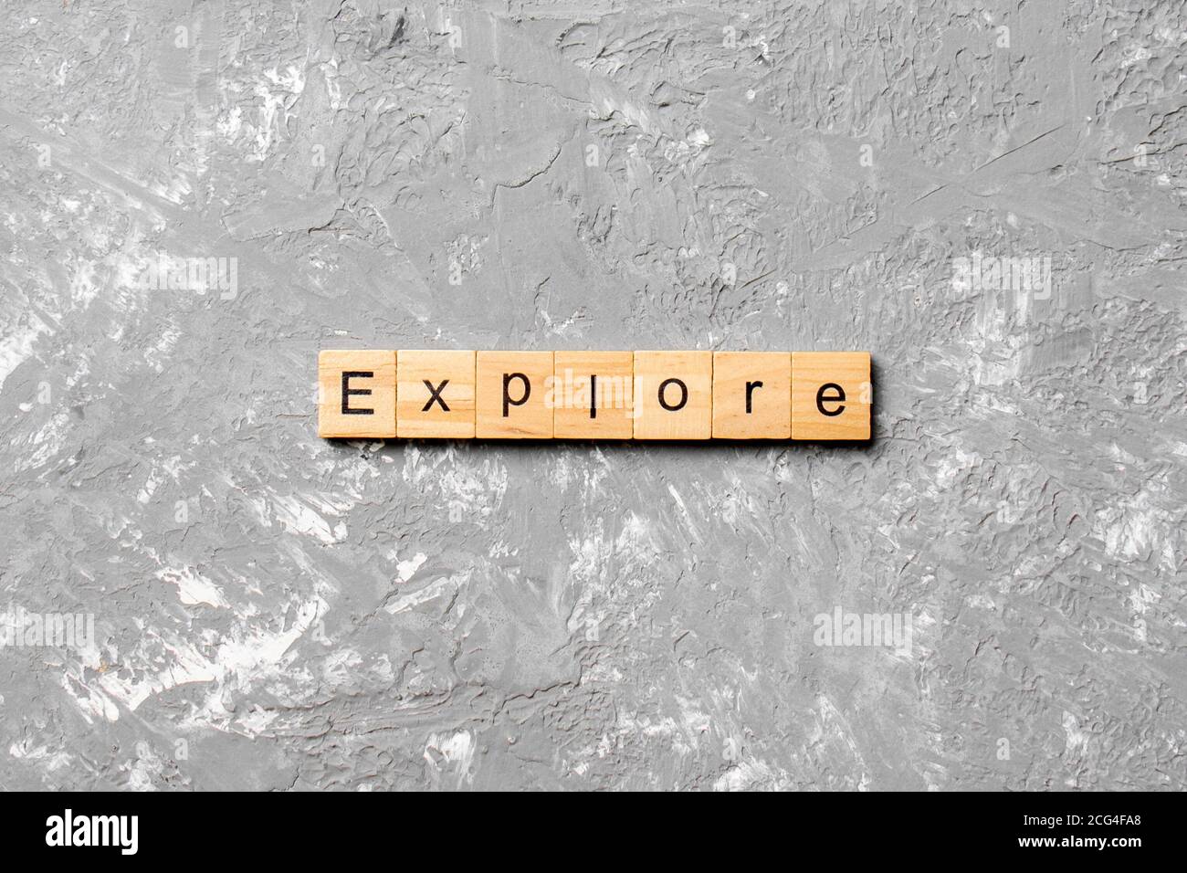 Explore word written on wood block. Explore text on cement table for ...