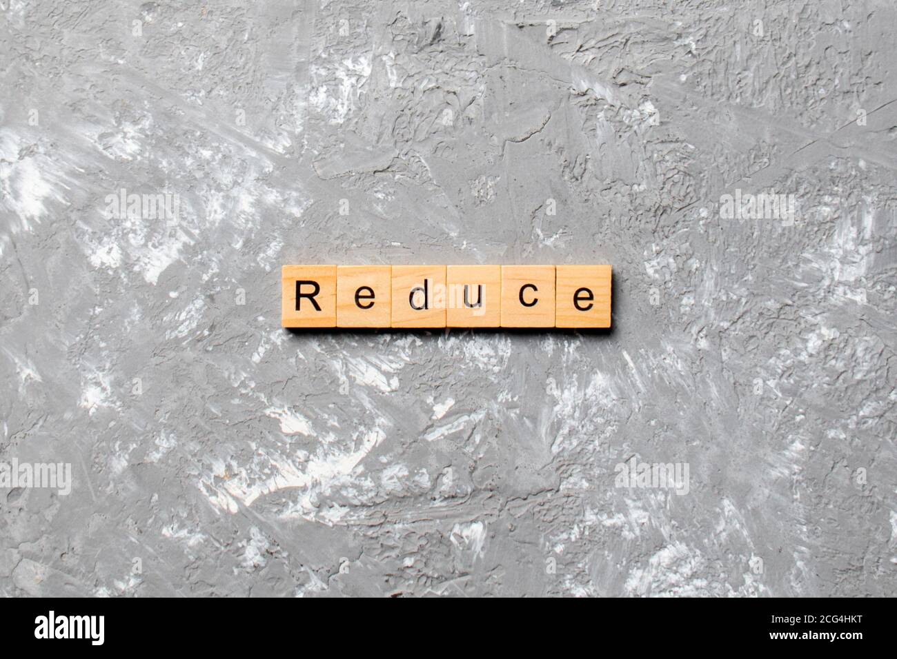 reduce word written on wood block. reduce text on cement table for your ...