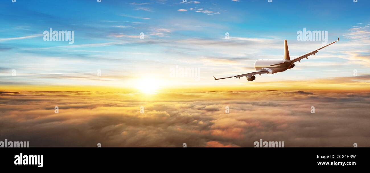 Commercial airplane flying above clouds, backside view. Sunset light ...