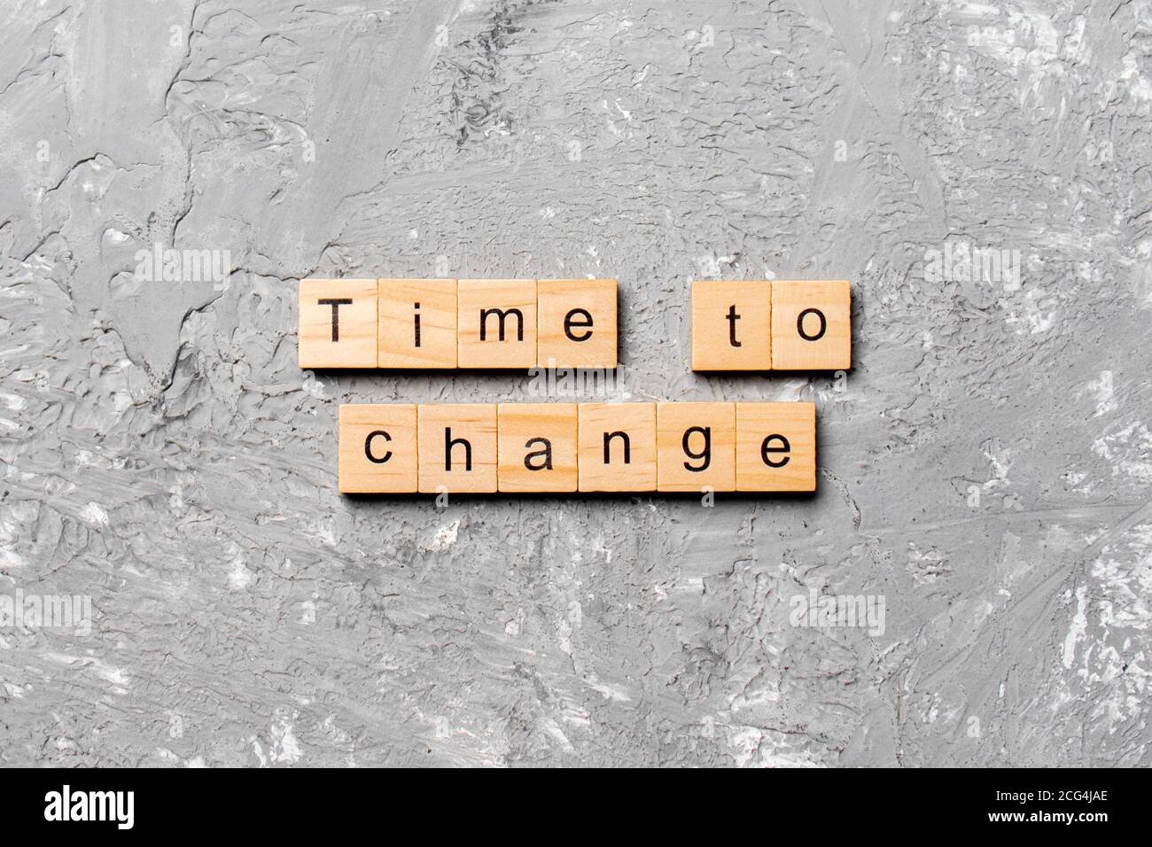 TIME TO CHANGE word written on wood block. TIME TO CHANGE text on table ...
