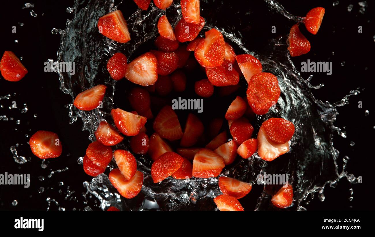 Freeze motion of rotating strawberries with ice cubes and water ...
