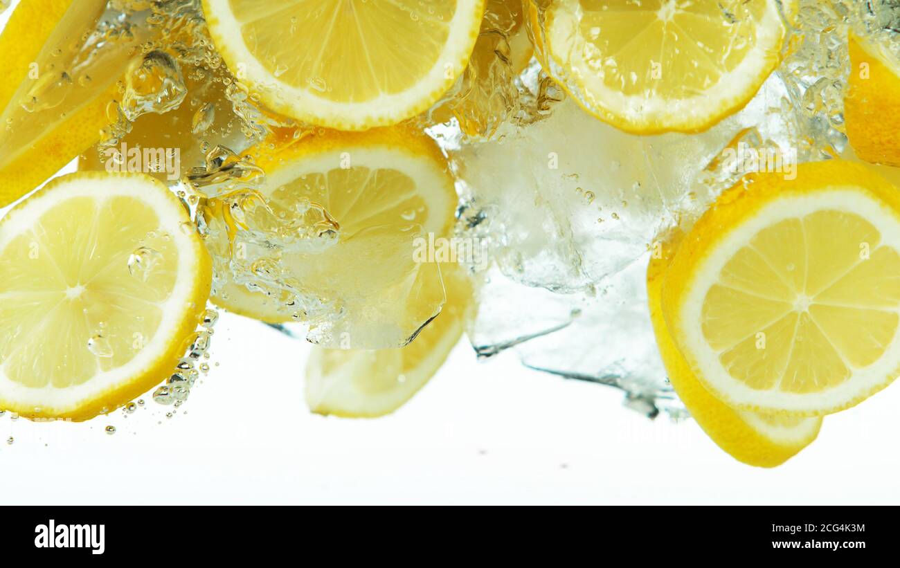 Lemon Slices with ice cubes falling deeply under water isolated on white background Stock Photo ...