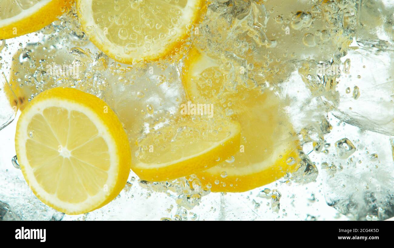 Lemon Slices with ice cubes falling deeply under water isolated on white background Stock Photo ...