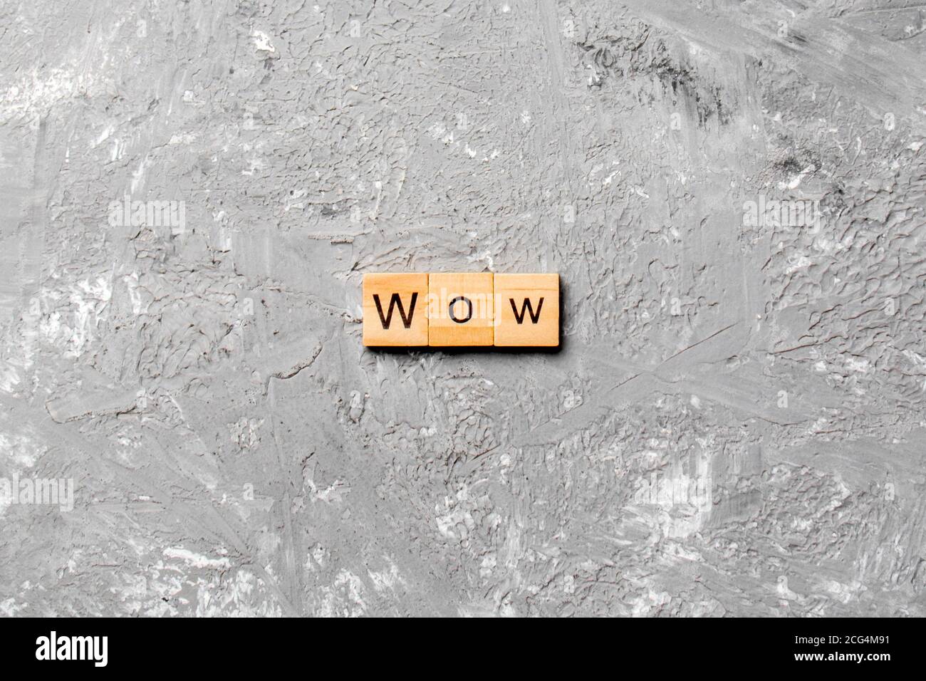 WOW word written on wood block. WOW text on cement table for your ...