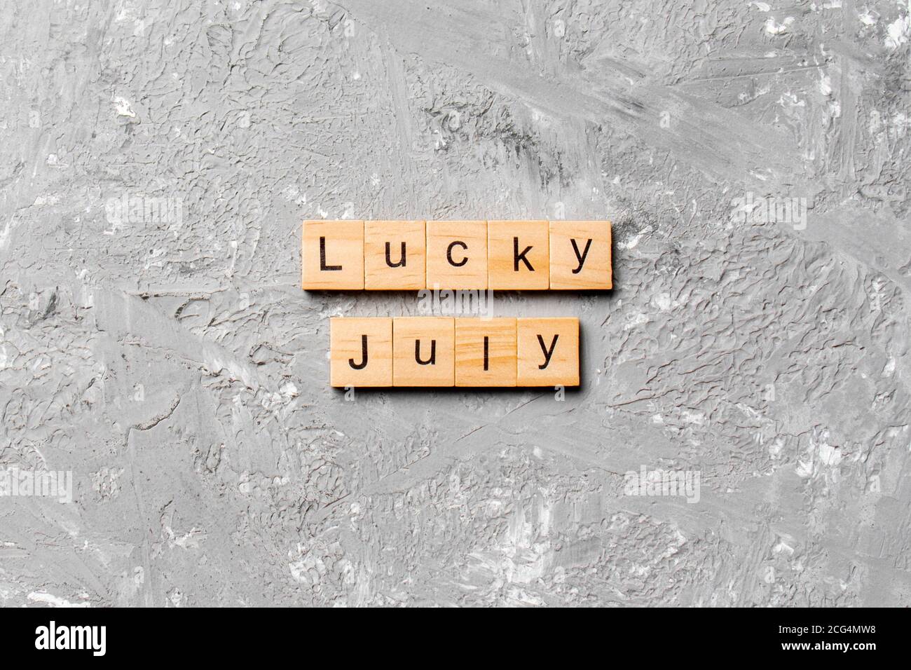 lucky july word written on wood block. Happy july text on table ...