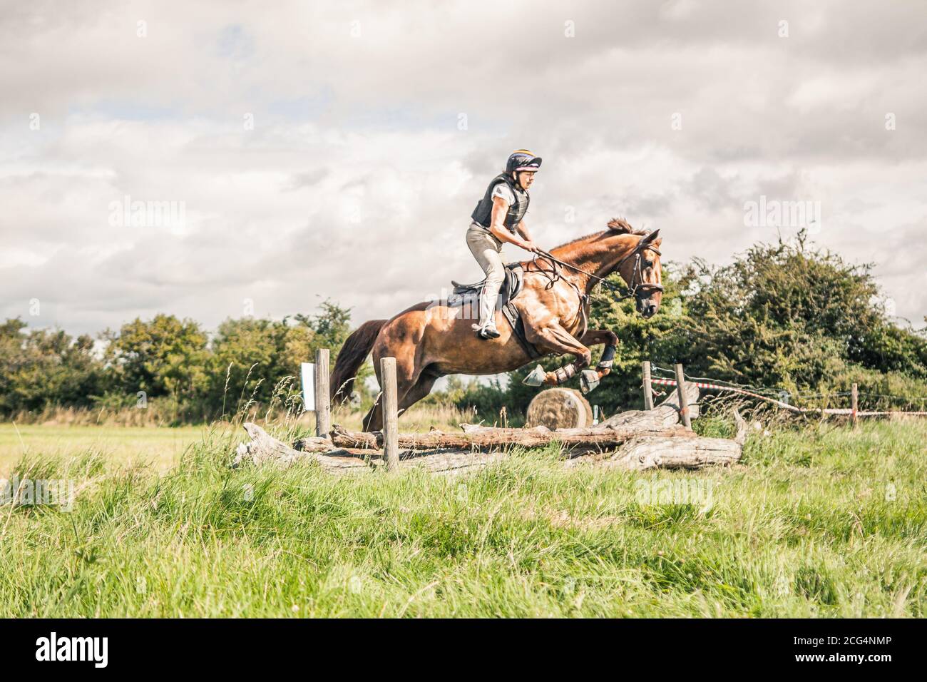 HORSE RIDING THROUGH FIELDS AND OVER JUMPS Stock Photo - Alamy