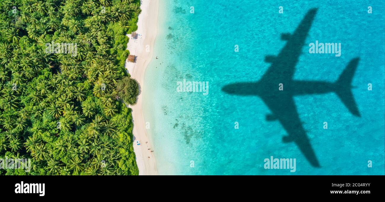 Travel concept with airplane shadow and tropical beach. Tropical ...