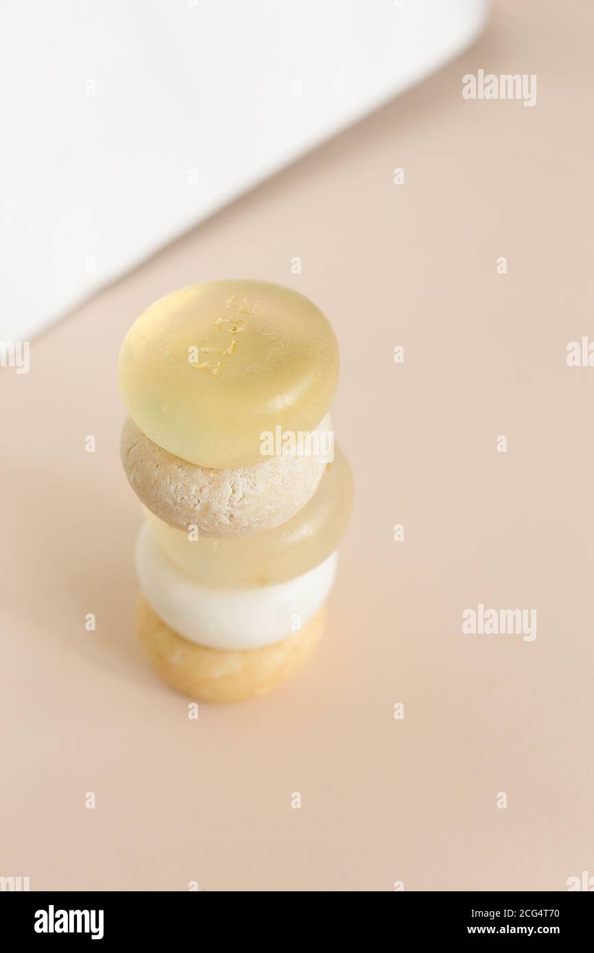 Five bars of natural handmade translucent soap in light background ...