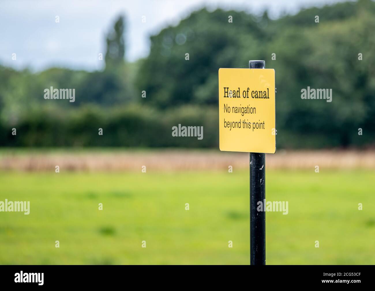 Yellow sign on black metal post with warning Head of Canal No ...