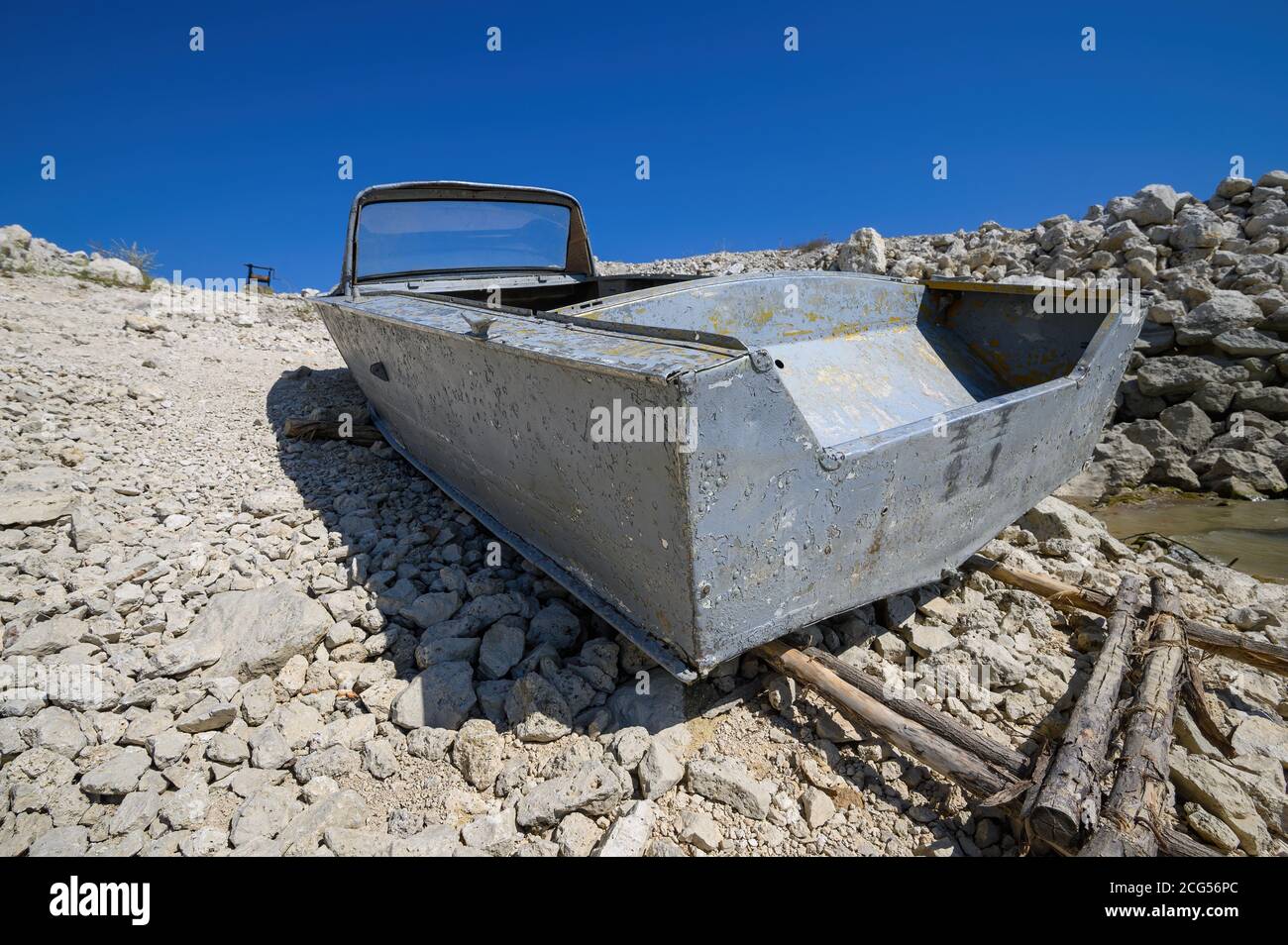 Empty old metal fishing motor boat at shore Stock Photo - Alamy