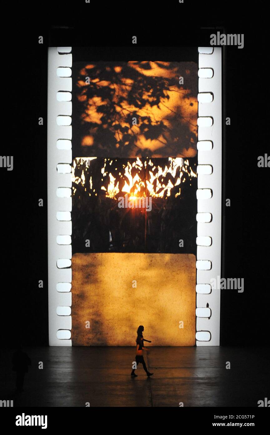 A visitors walks by the screen at the unveiling of a new work FILM, in ...