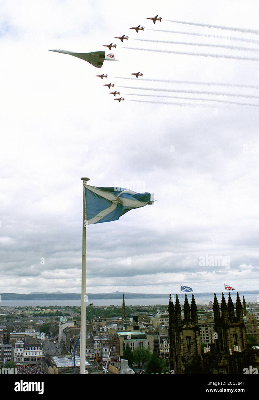 A Concorde jet, flanked by the Red Arrows, makes a flypast over the ...