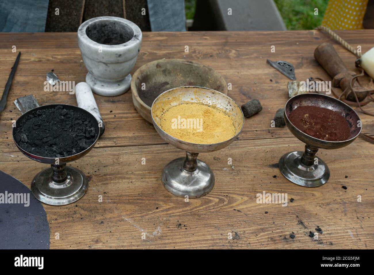 charcoal, sulfur, saltpeter in bowls for making black powder. ?asting ...