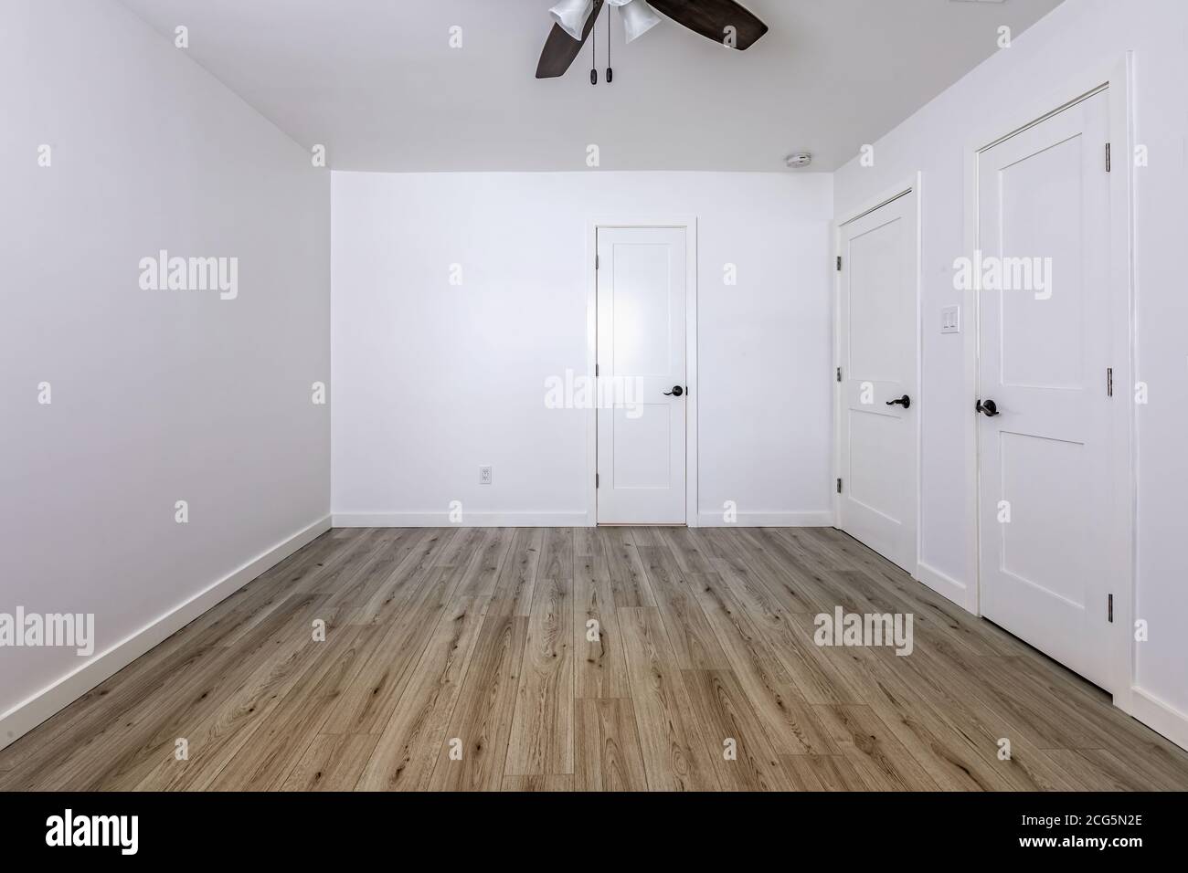 Empty bedroom with open doors leading to the livingroom, bathroom and a ...