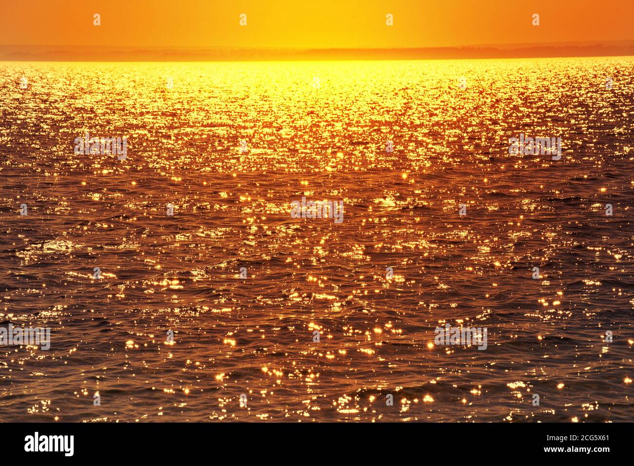 Glittering water at sunset. Sea water background Stock Photo - Alamy
