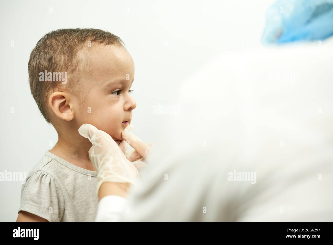 Pediatrician checking baby teeth. Dentist examines teeth of baby boy ...