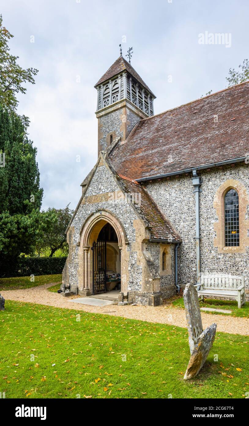 Entrance to the parish church of All Saints with flint lined walls ...
