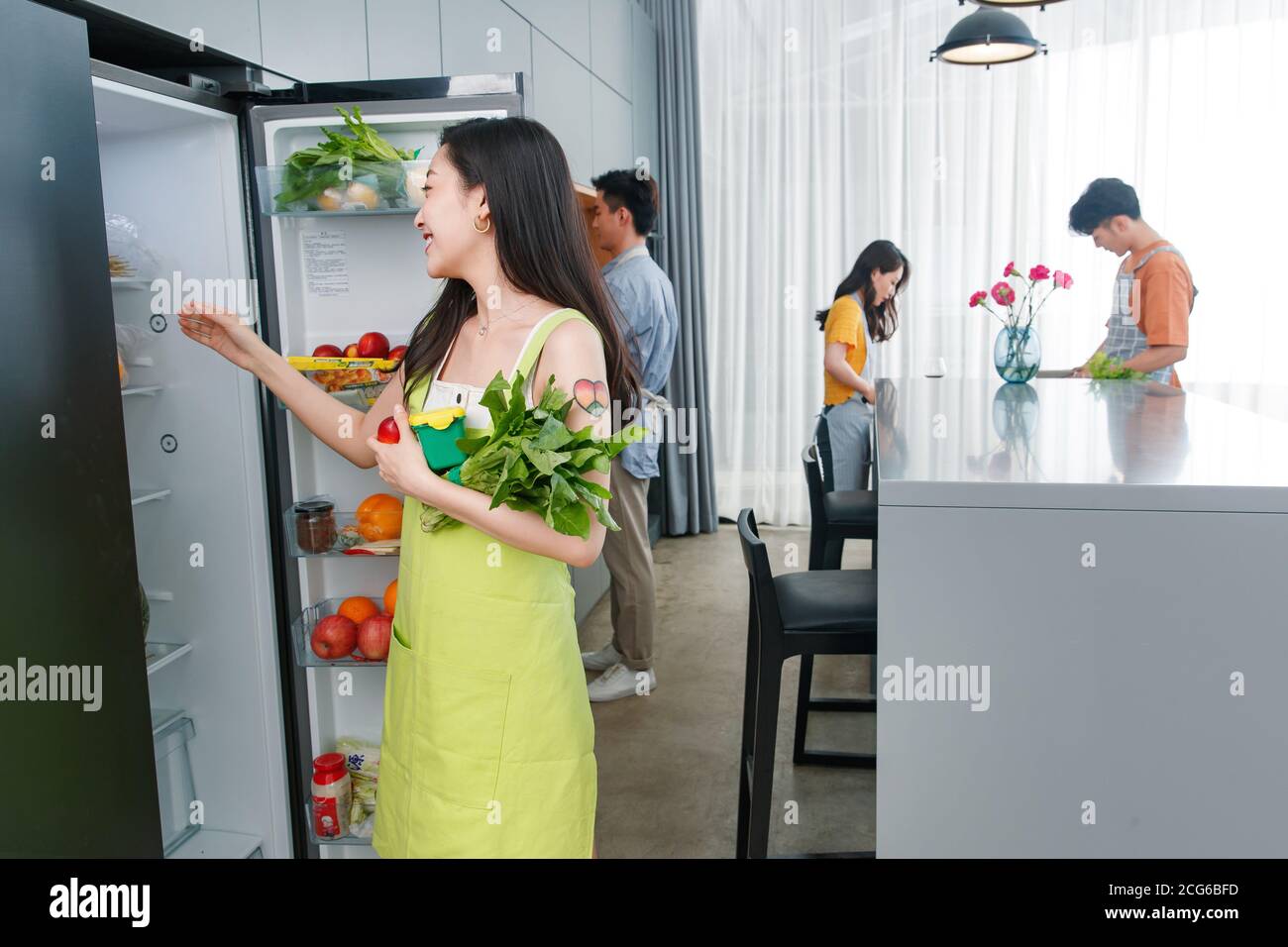Happy young people cook in the kitchen Stock Photo - Alamy