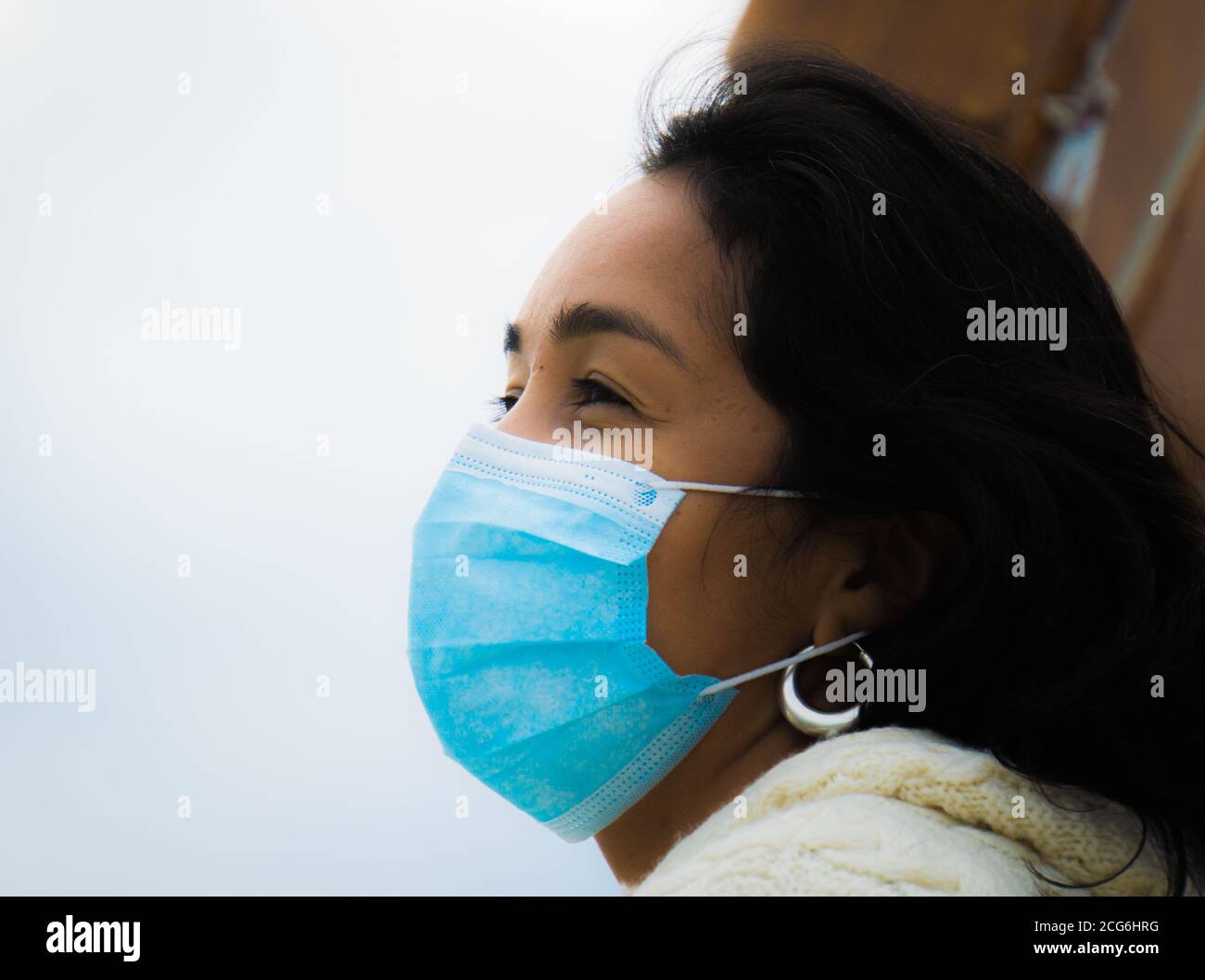 young woman wearing mask enjoying sailing in the time of the Covid-19 ...