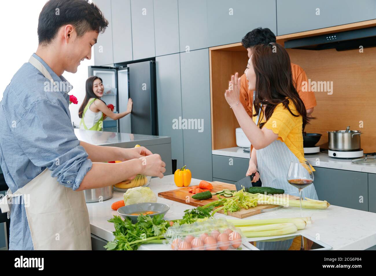 Happy young people cook in the kitchen Stock Photo - Alamy