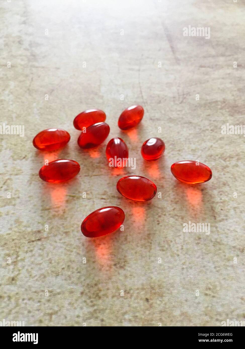 Red capsules on a table Stock Photo - Alamy