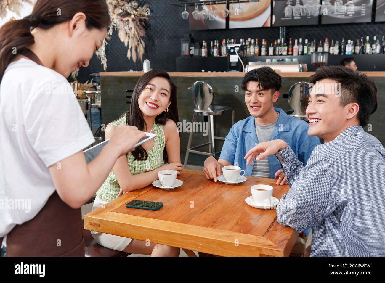 Young friends in a cafe Stock Photo - Alamy