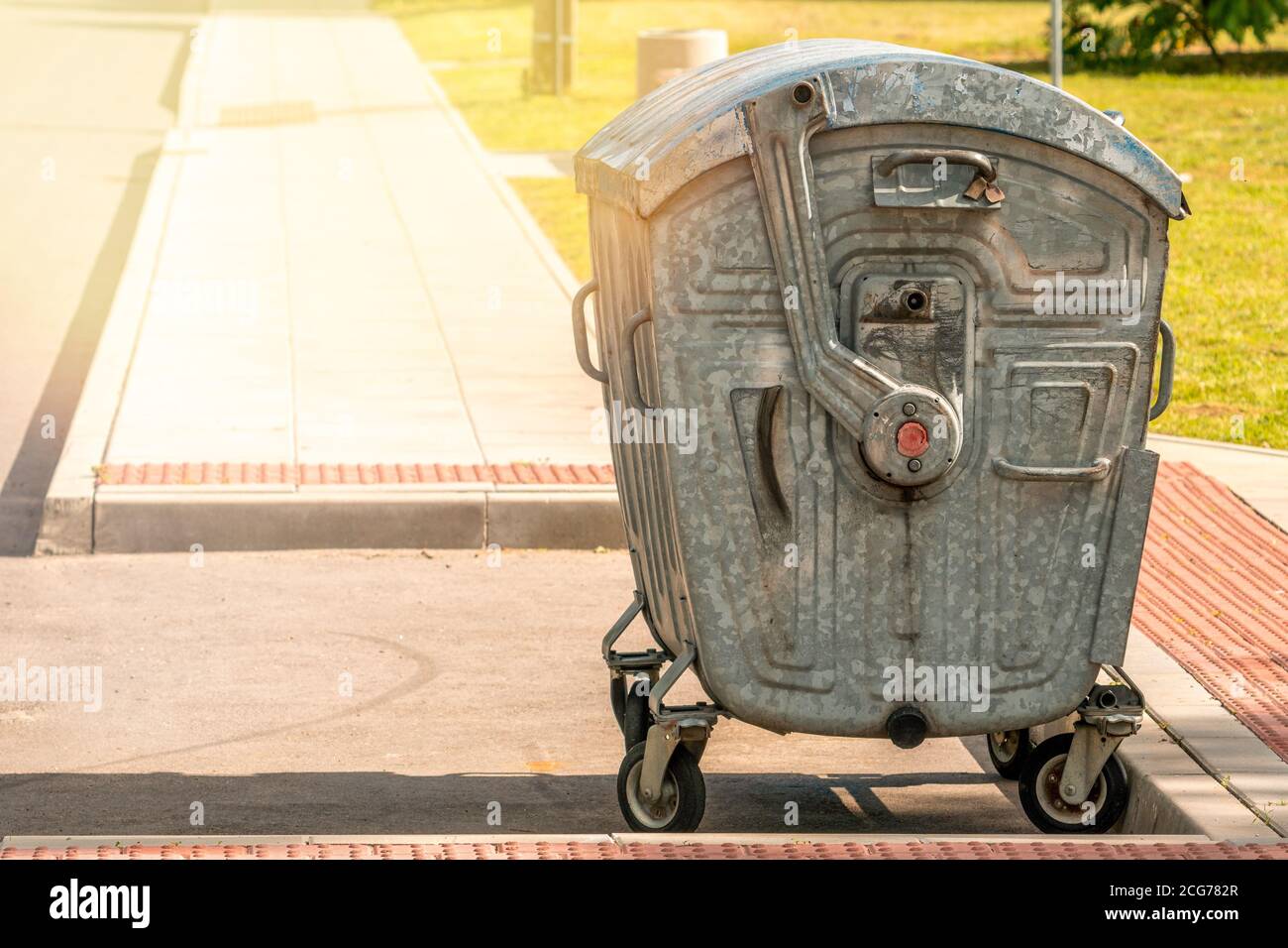 Metal container for garbage on the street of small town Stock Photo - Alamy