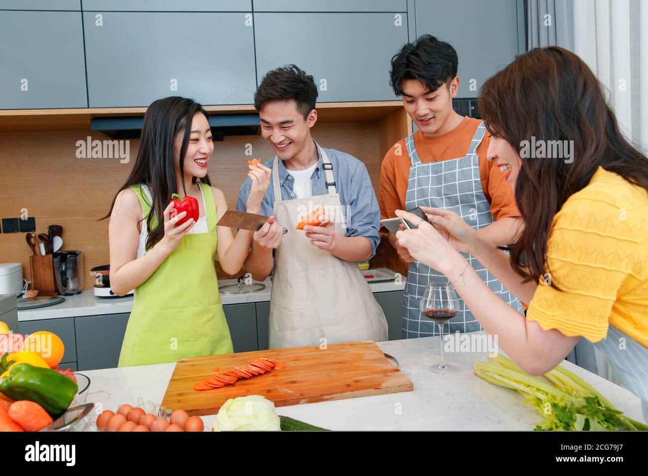 Happy young people cook in the kitchen Stock Photo - Alamy
