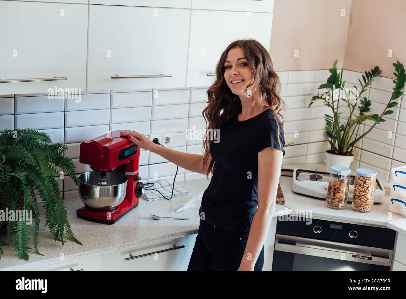 Beautiful woman pastry chef makes sweet cream Stock Photo - Alamy