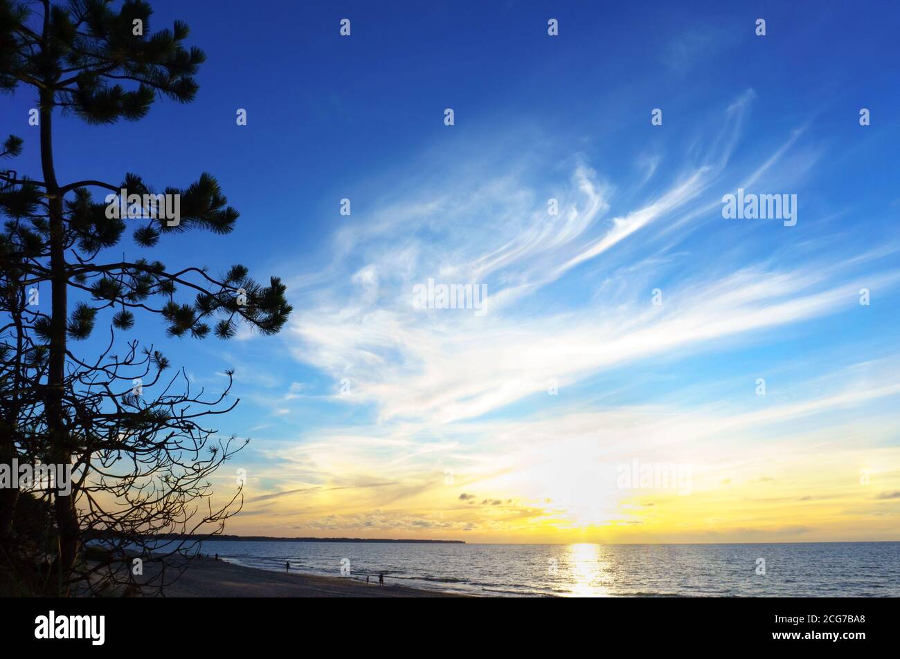 the sun going below the horizon of the sea, sunset on the sea coast ...