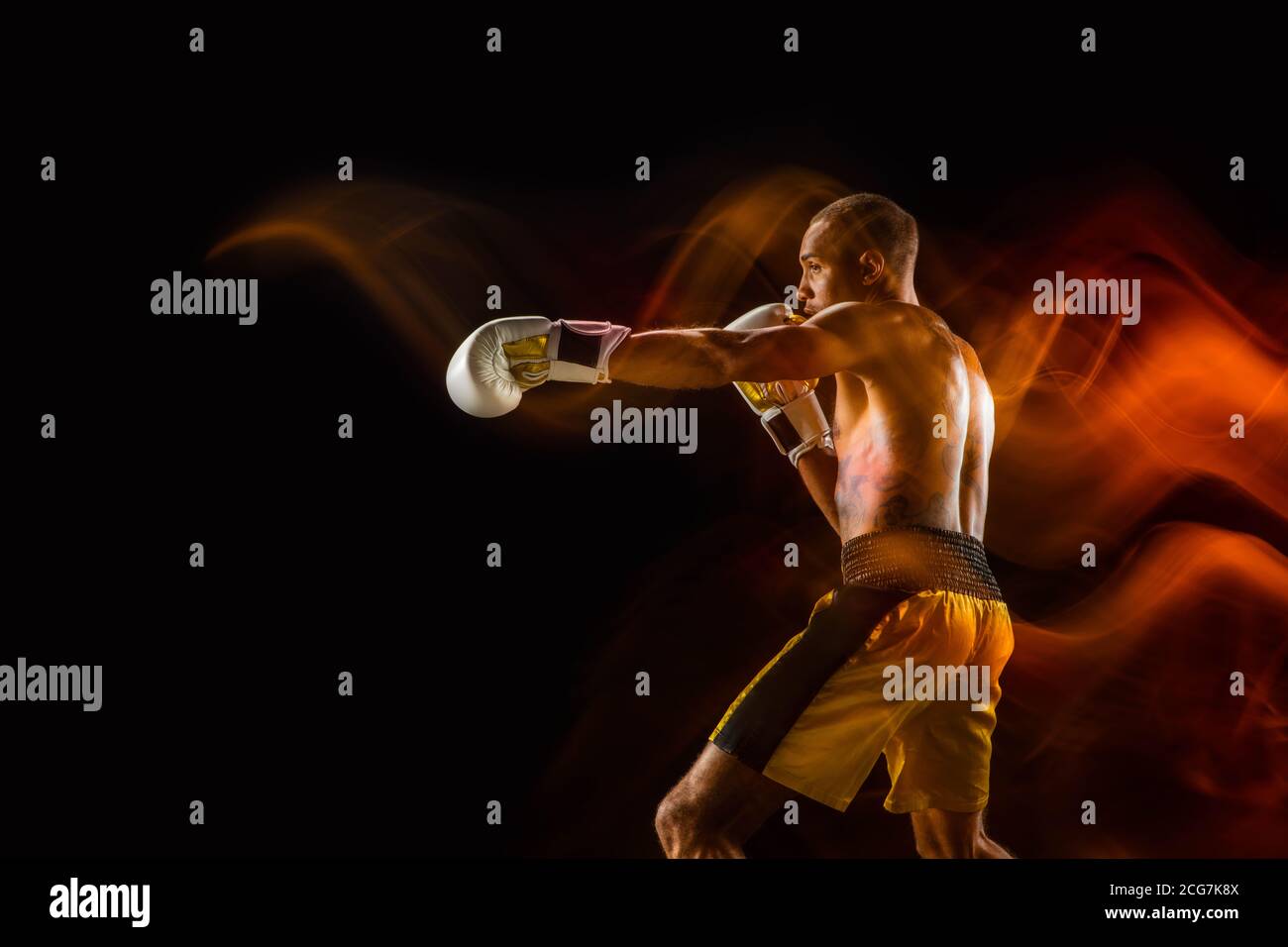 Fireball. Professional boxer training isolated on black studio ...