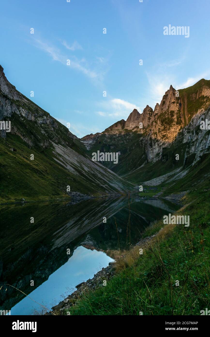 The moon and the Alpstein mountain range reflecting on the Faelensee ...
