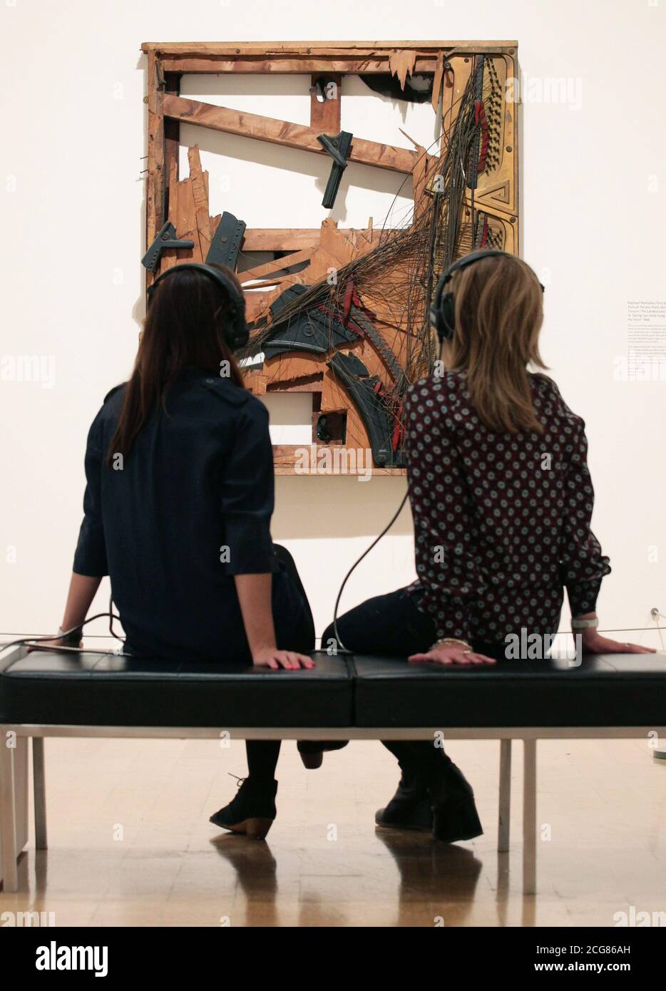 Gallery staff listen on headphones to a recording of the destruction of ...
