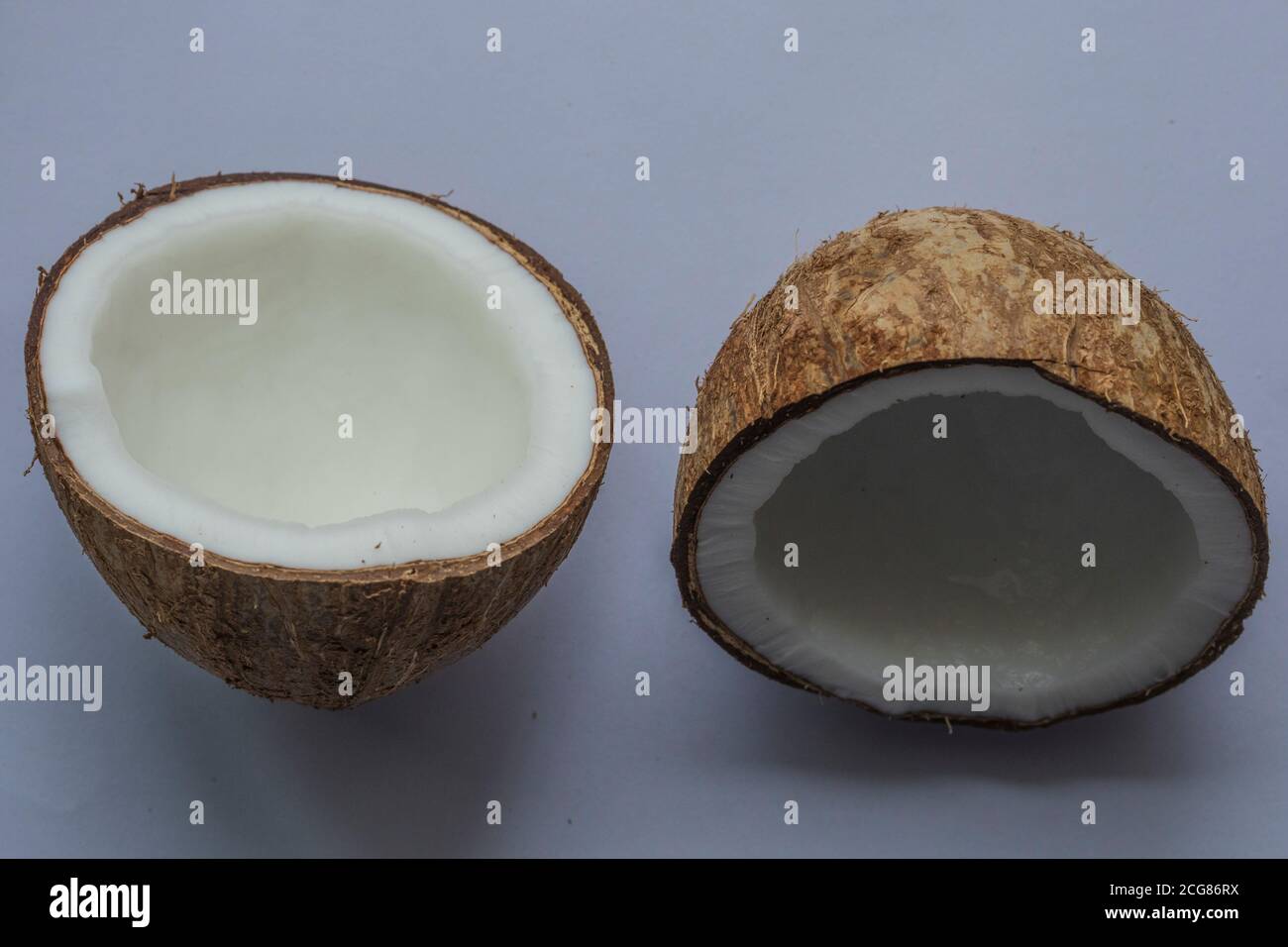 Two halves of a coconut on white background Stock Photo - Alamy