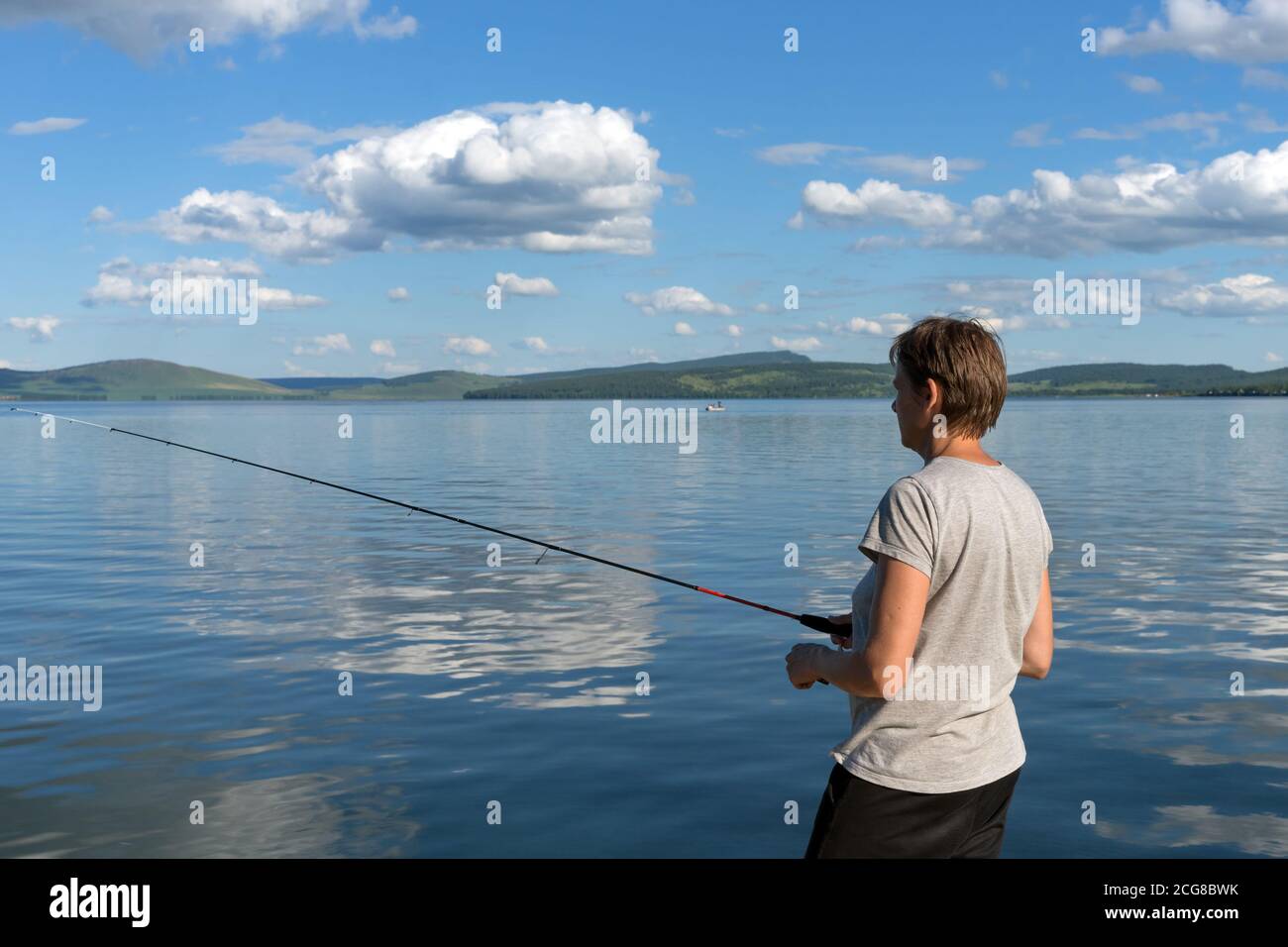 Woman catches fish on rod hi-res stock photography and images - Alamy
