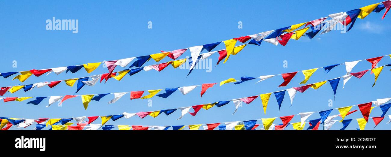 multi colored party rainbow flags on blue sky for celebration. Flags ...