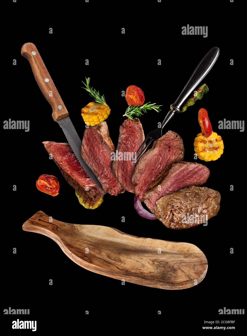 Flying beef steaks with grilled vegetable served on plate. Concept of ...