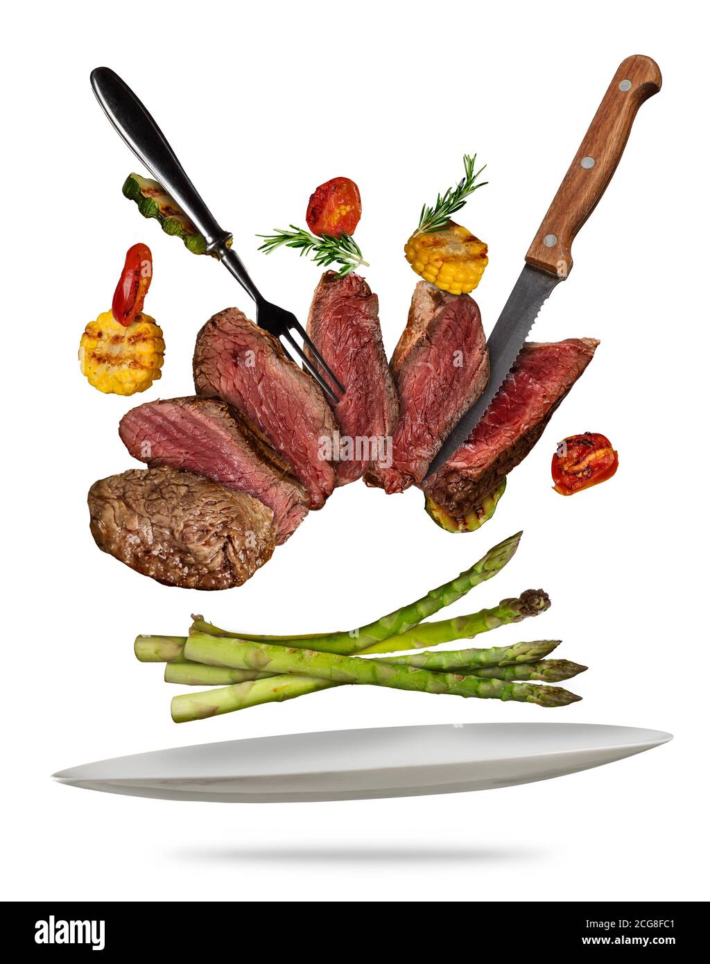 Flying beef steaks with grilled vegetable served on plate. Concept of ...