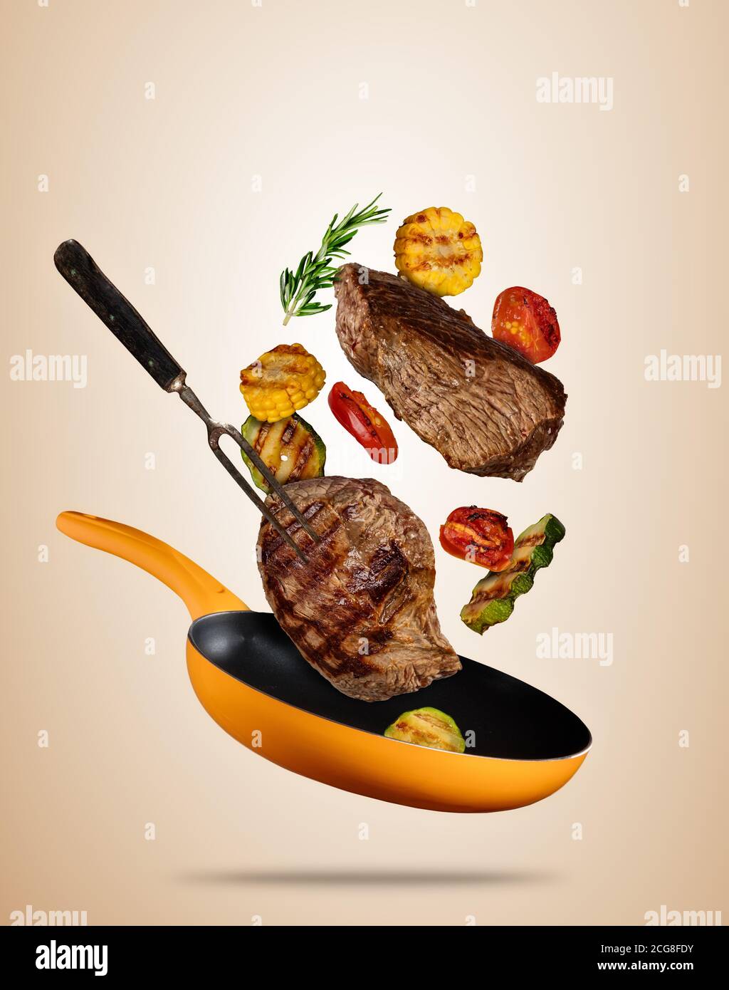 Flying beef steaks with grilled vegetable on pan. Concept of flying ...