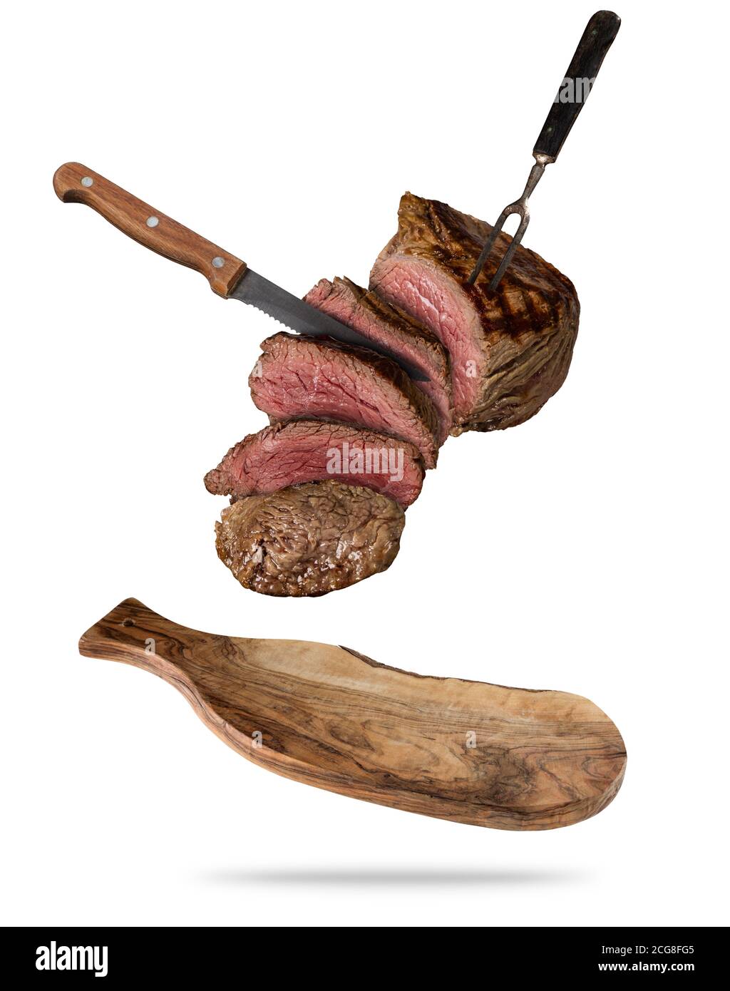 Flying beef steaks served on wooden cutting board. Concept of flying ...