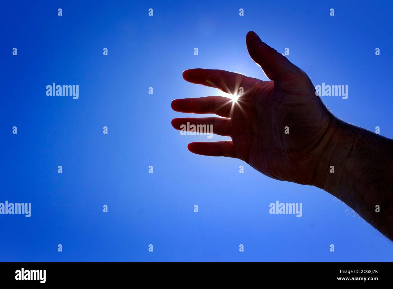 Hand reaching up towards heaven seeking help with sunstar sunshine ...